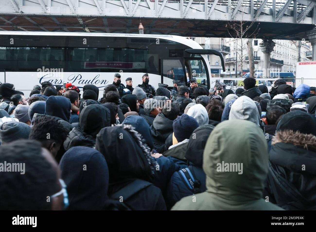 A group of refugees waiting to board buses. Evacuation of a camp of ...
