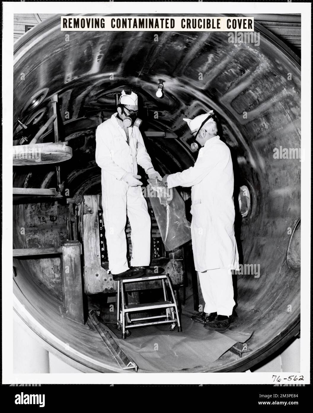 Removing contaminated crucible cover , Ordnance industry, Armories ...