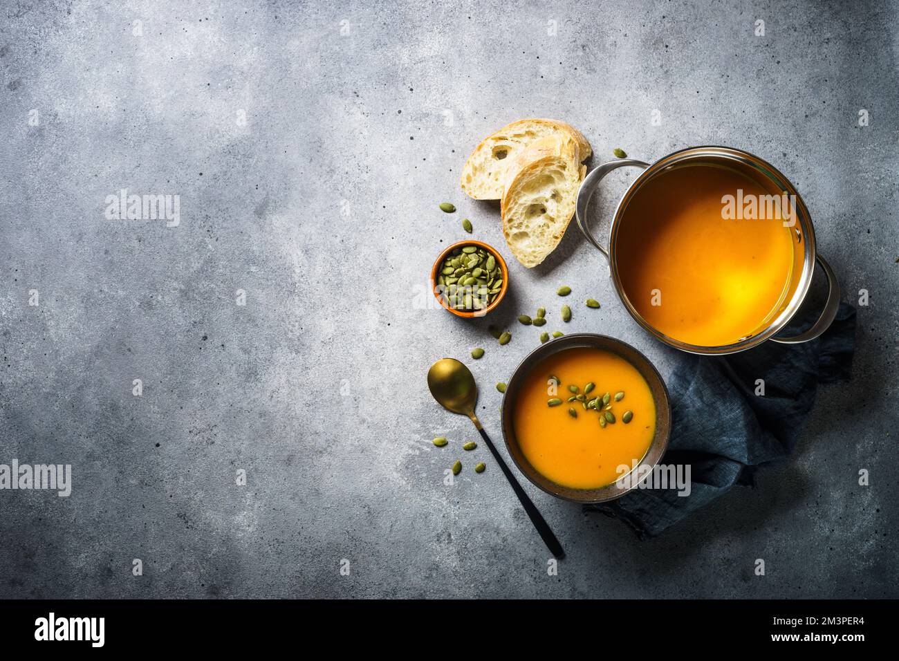 Pumpkin soup in the pot at stone table Stock Photo - Alamy