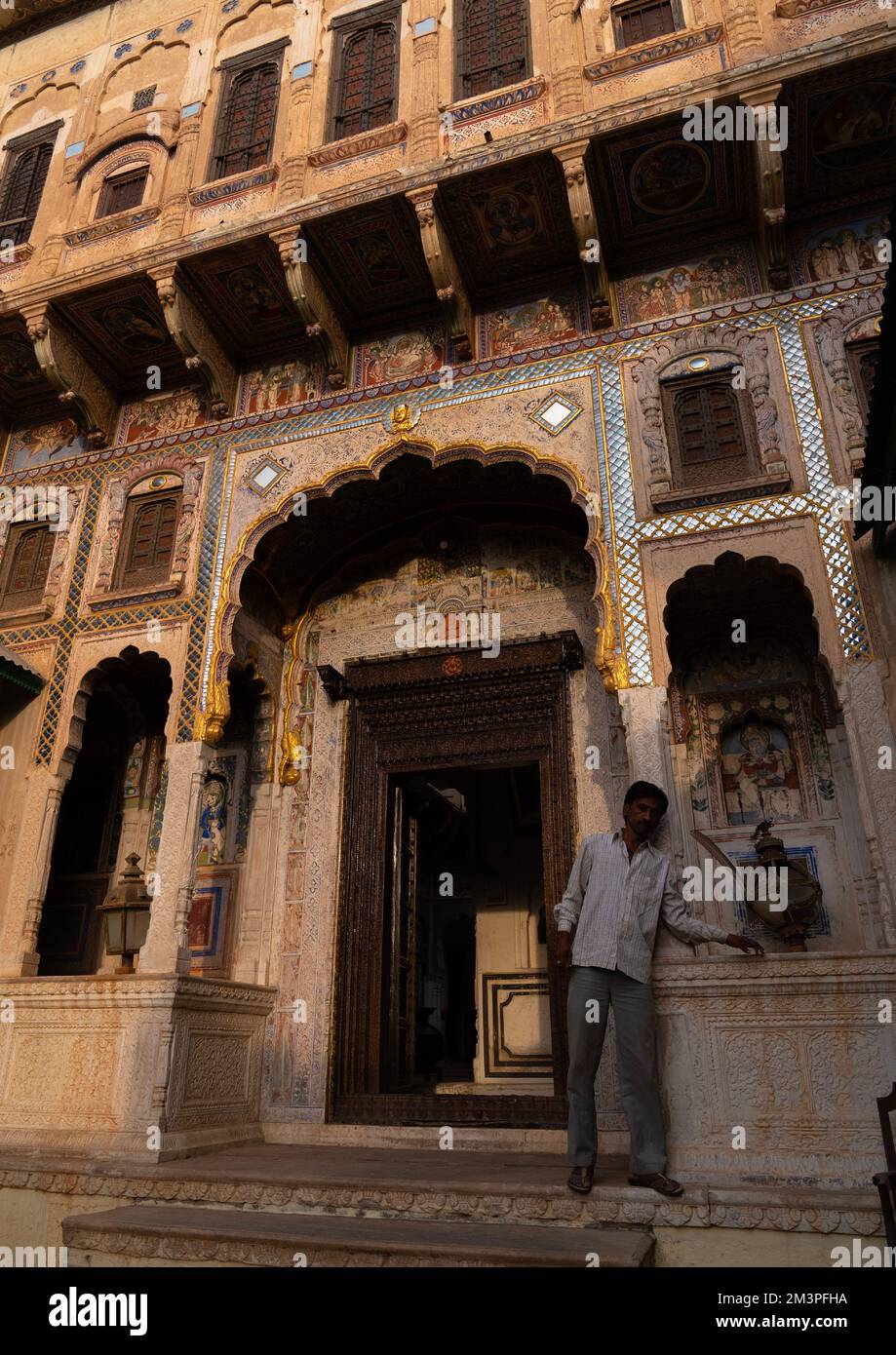 Indian man standing at Seth Arjun Das Goenka Haveli entrance, Rajasthan, Dundlod, India Stock ...