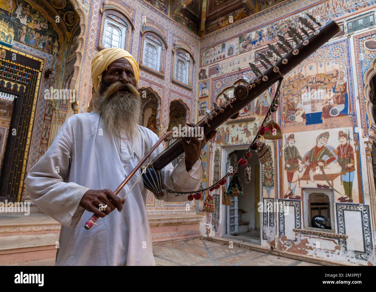 Musician playing sitar inside an old haveli courtyard, Rajasthan ...