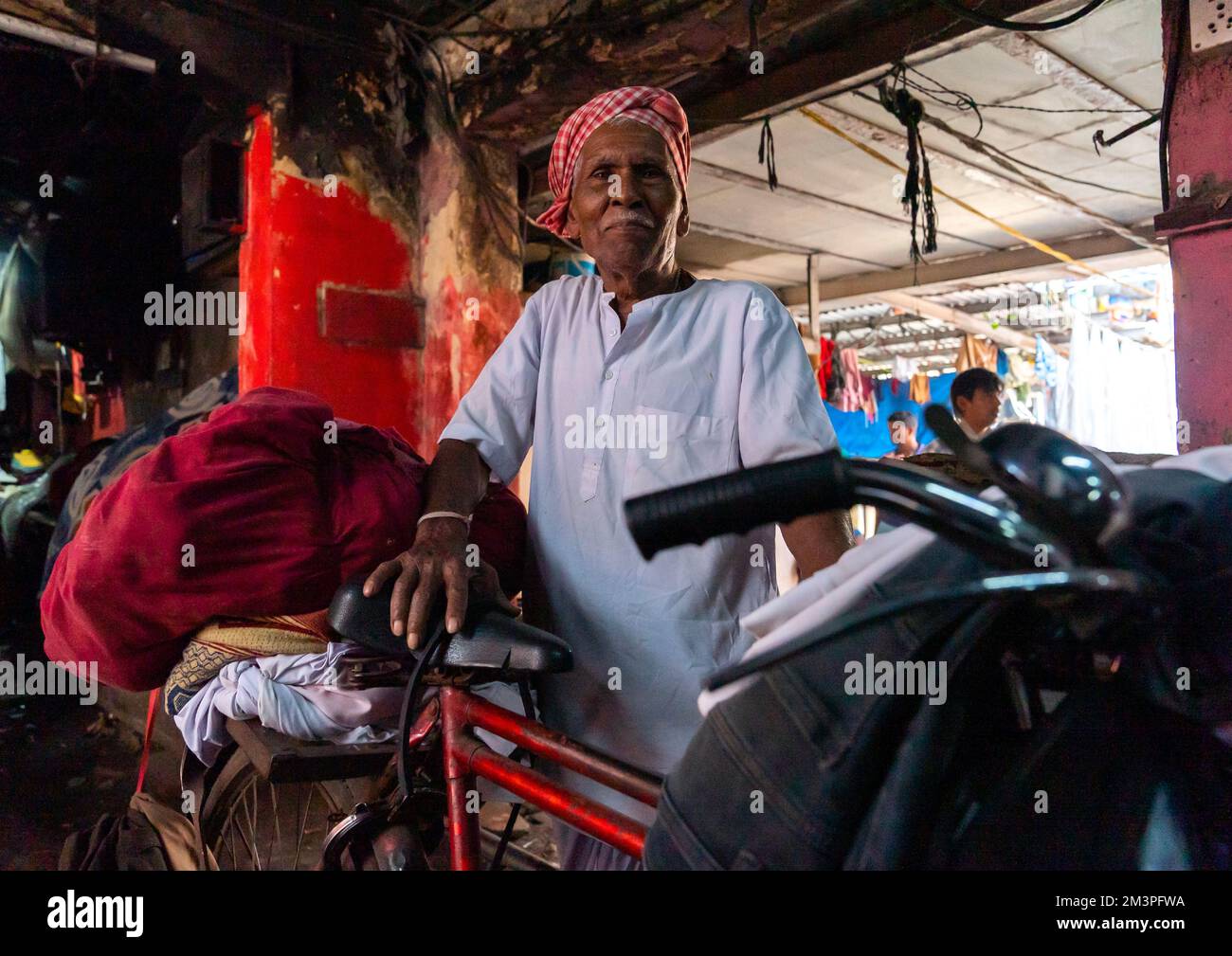 Laundry Worker with bicycle in Dhobi Ghat, Maharashtra state, Mumbai ...