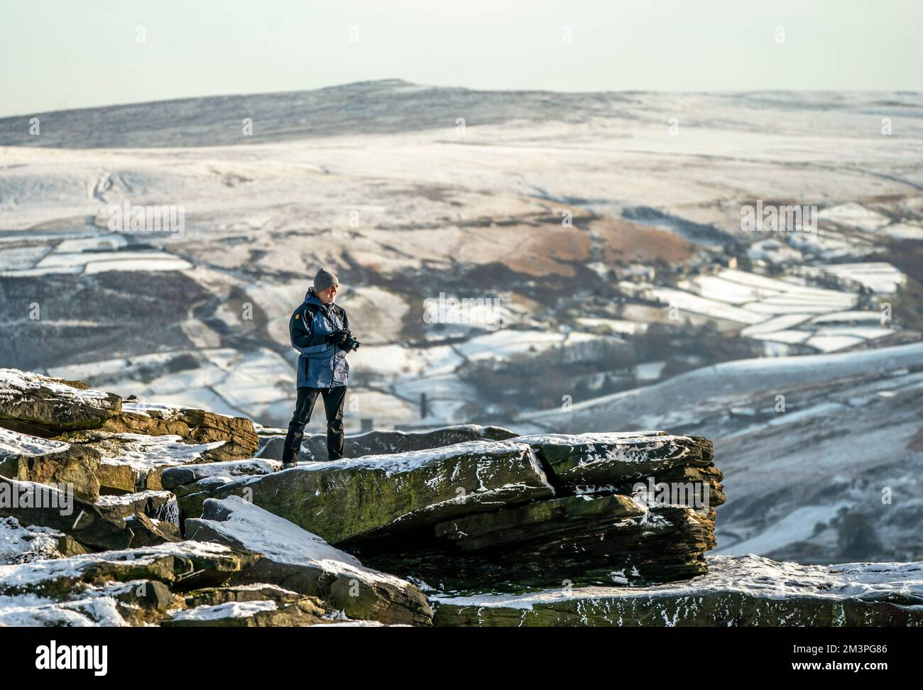 A man walks on Marsden Moor in the South Pennines. Snow and ice have ...