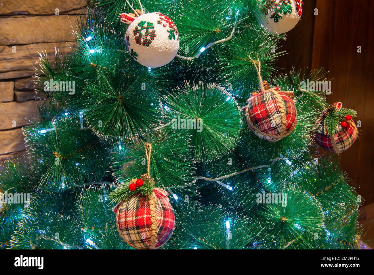 Closeup of large round bauble decorations hanging on festive artificial ...
