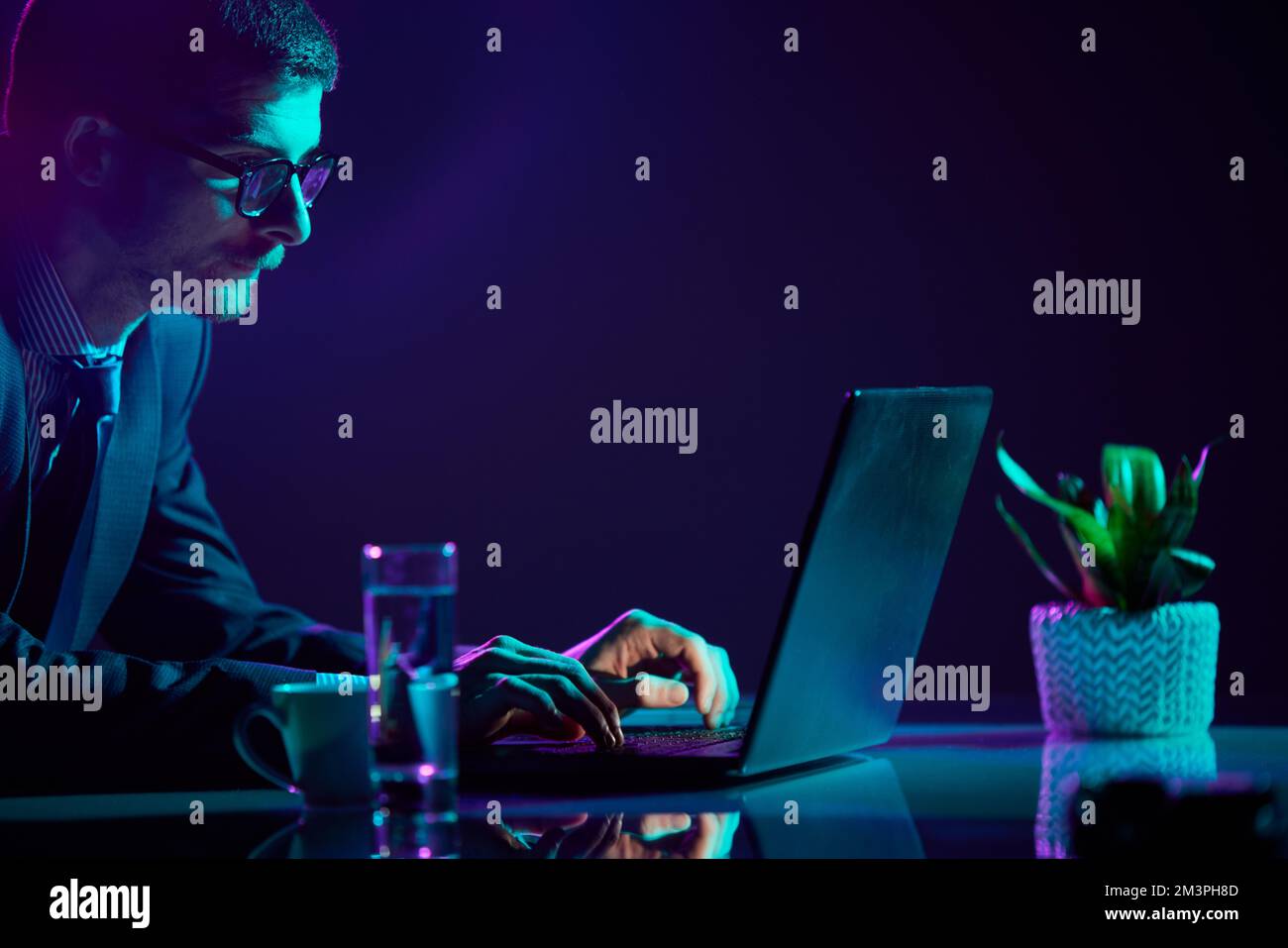 Serious young man, office manager and IT specialist sitting at office ...