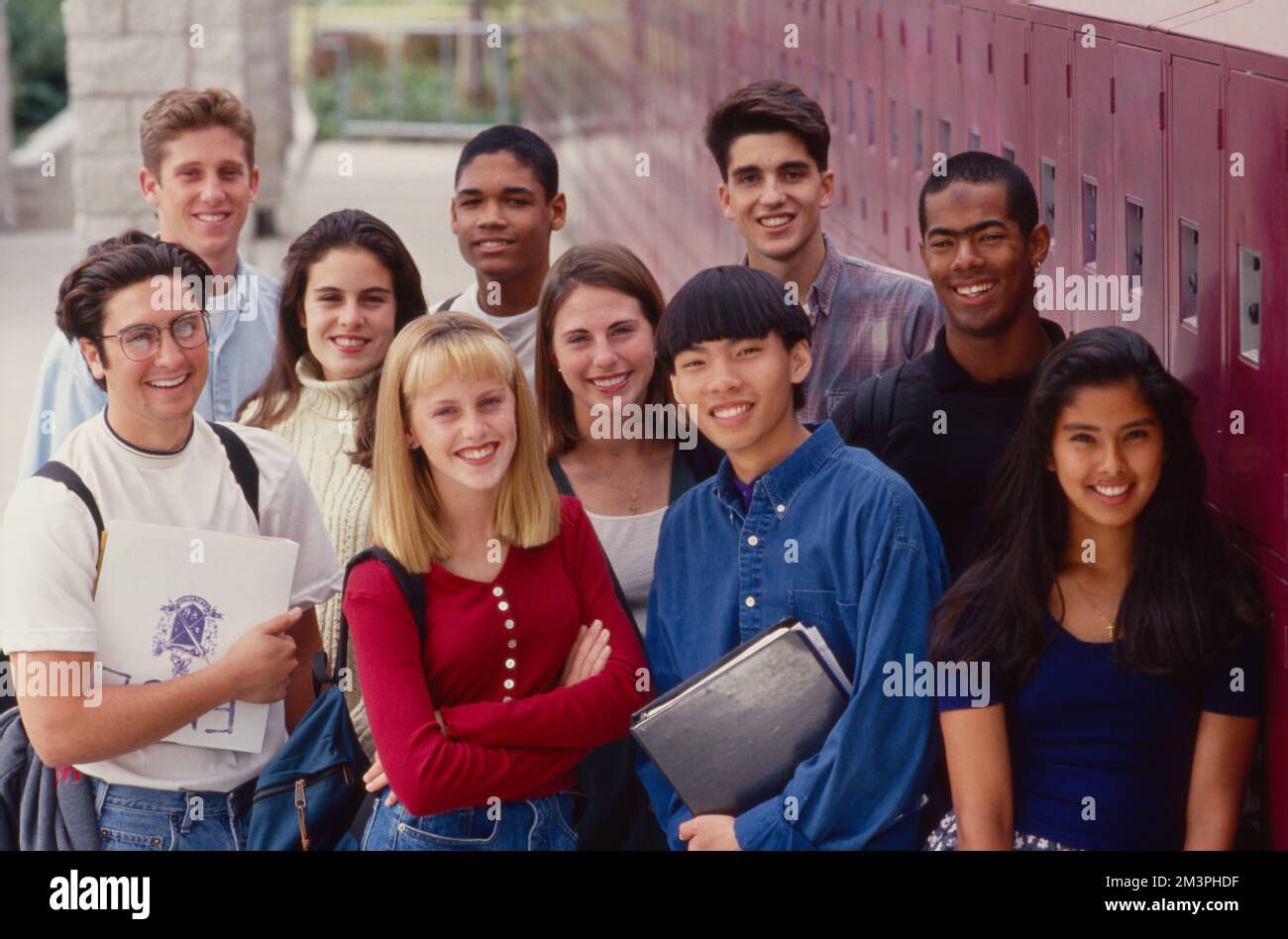 Group of high school aged boys and girls posing for a group photo in ...