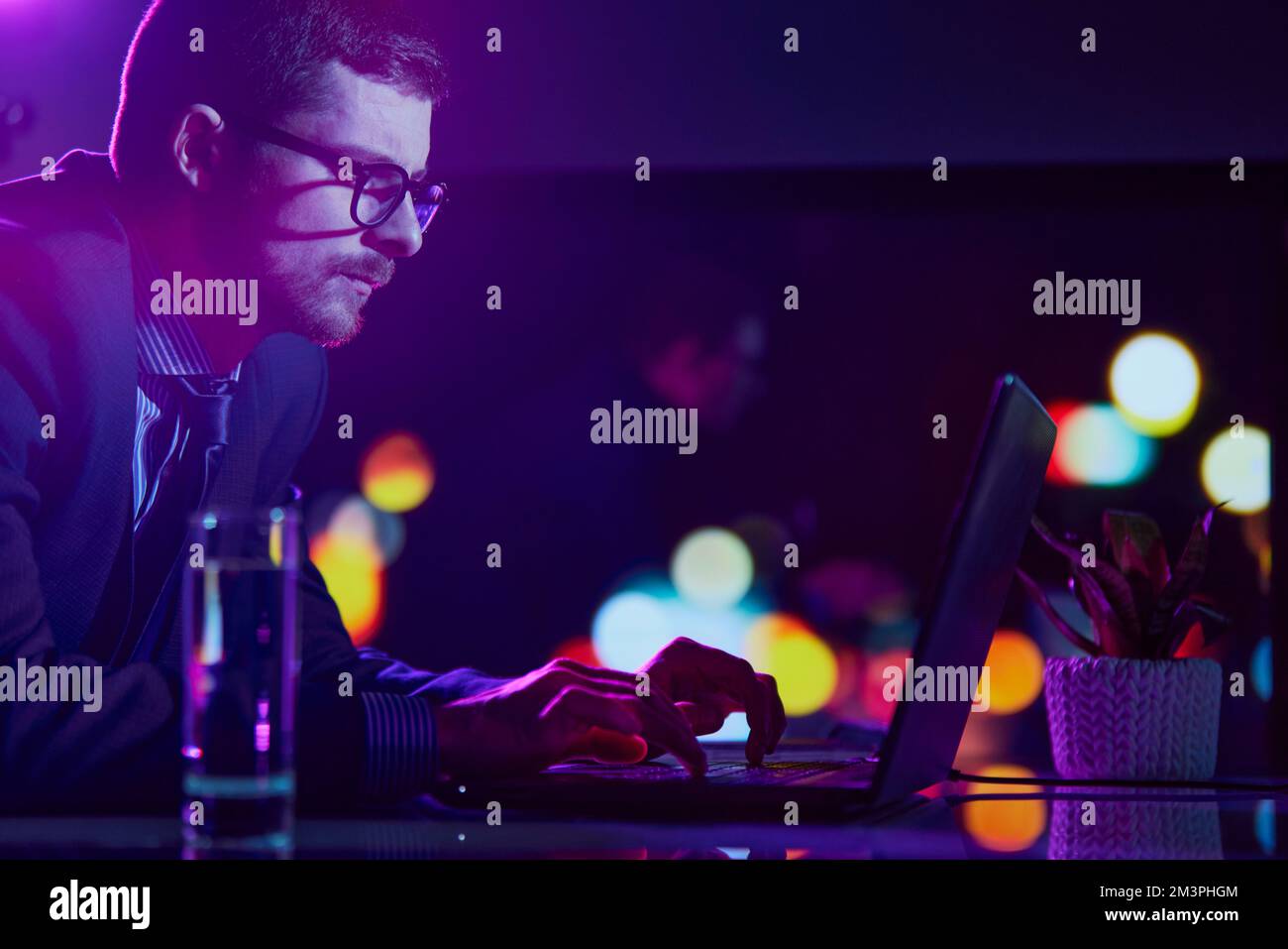 Serious young man, office manager and IT specialist sitting at office ...