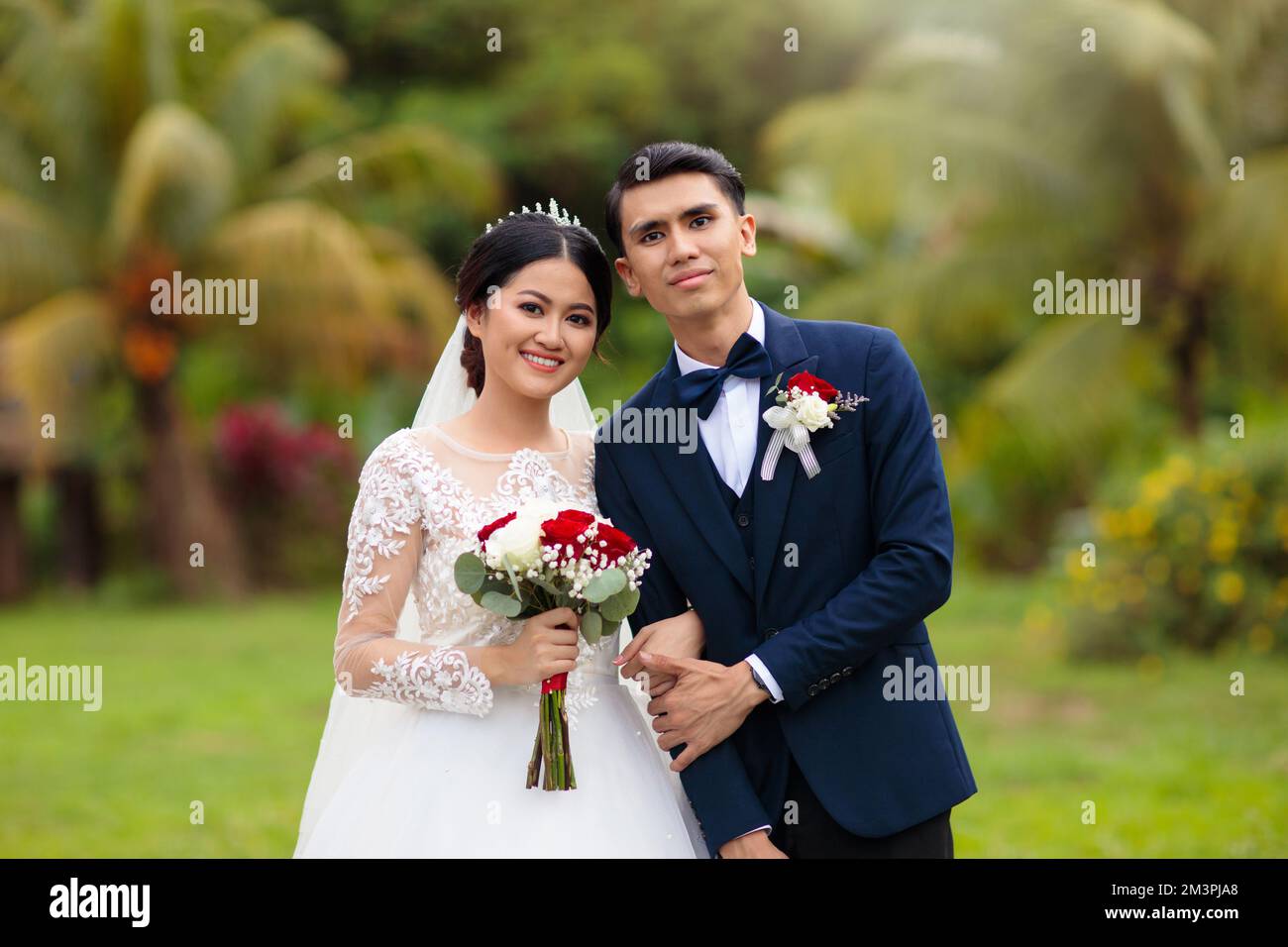 Bride and groom on wedding day. Beautiful young Asian couple. Newly wed ...