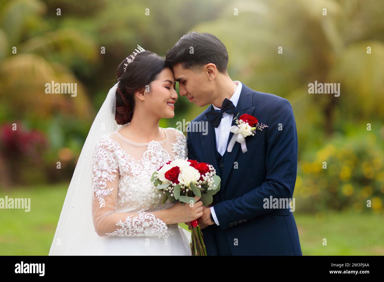 Bride and groom on wedding day. Beautiful young Asian couple. Newly wed ...