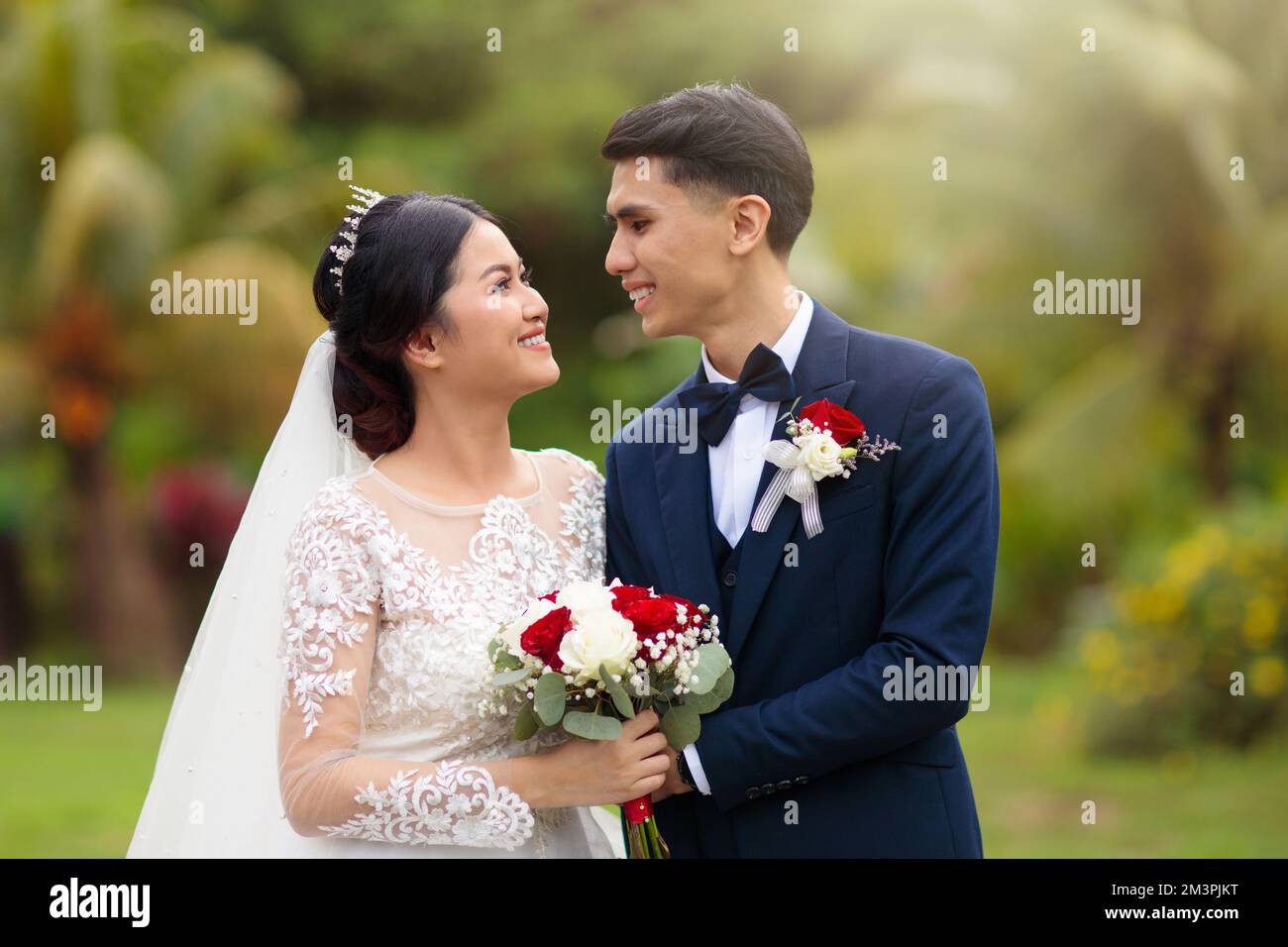 Bride and groom on wedding day. Beautiful young Asian couple. Newly wed ...