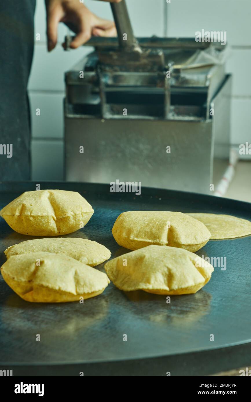 A vertical of Puri baking on a stove in the kitchen Stock Photo - Alamy