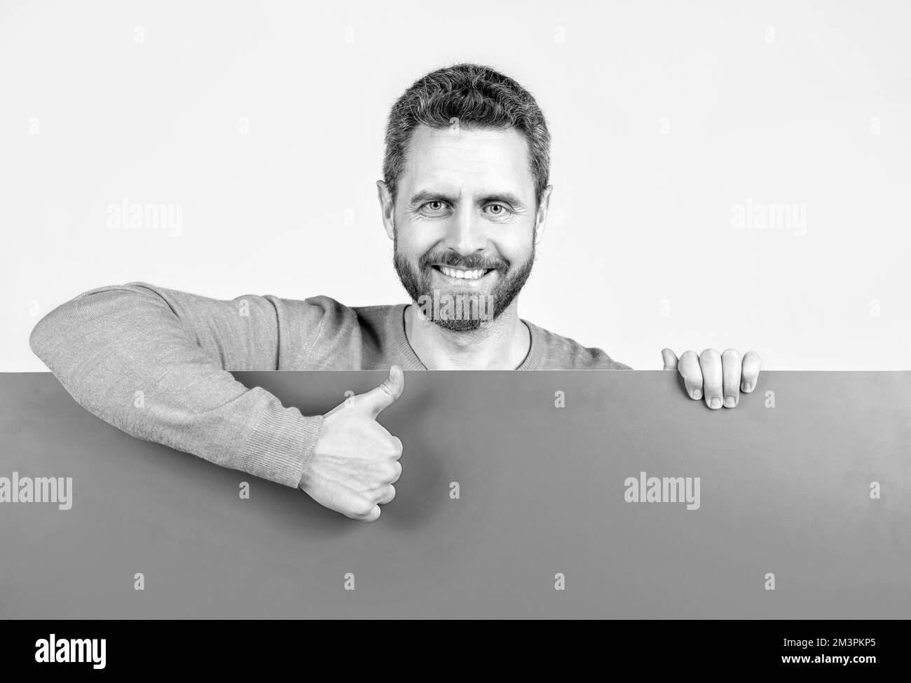 happy man behind blank paper banner with copy space for job offer show ...