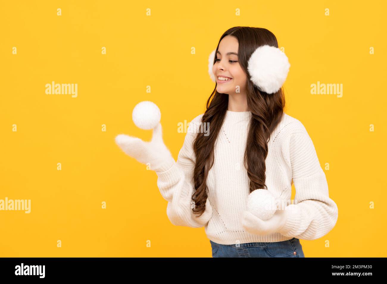 Portrait of happy teenager child girl wears sweater and knitted gloves ...