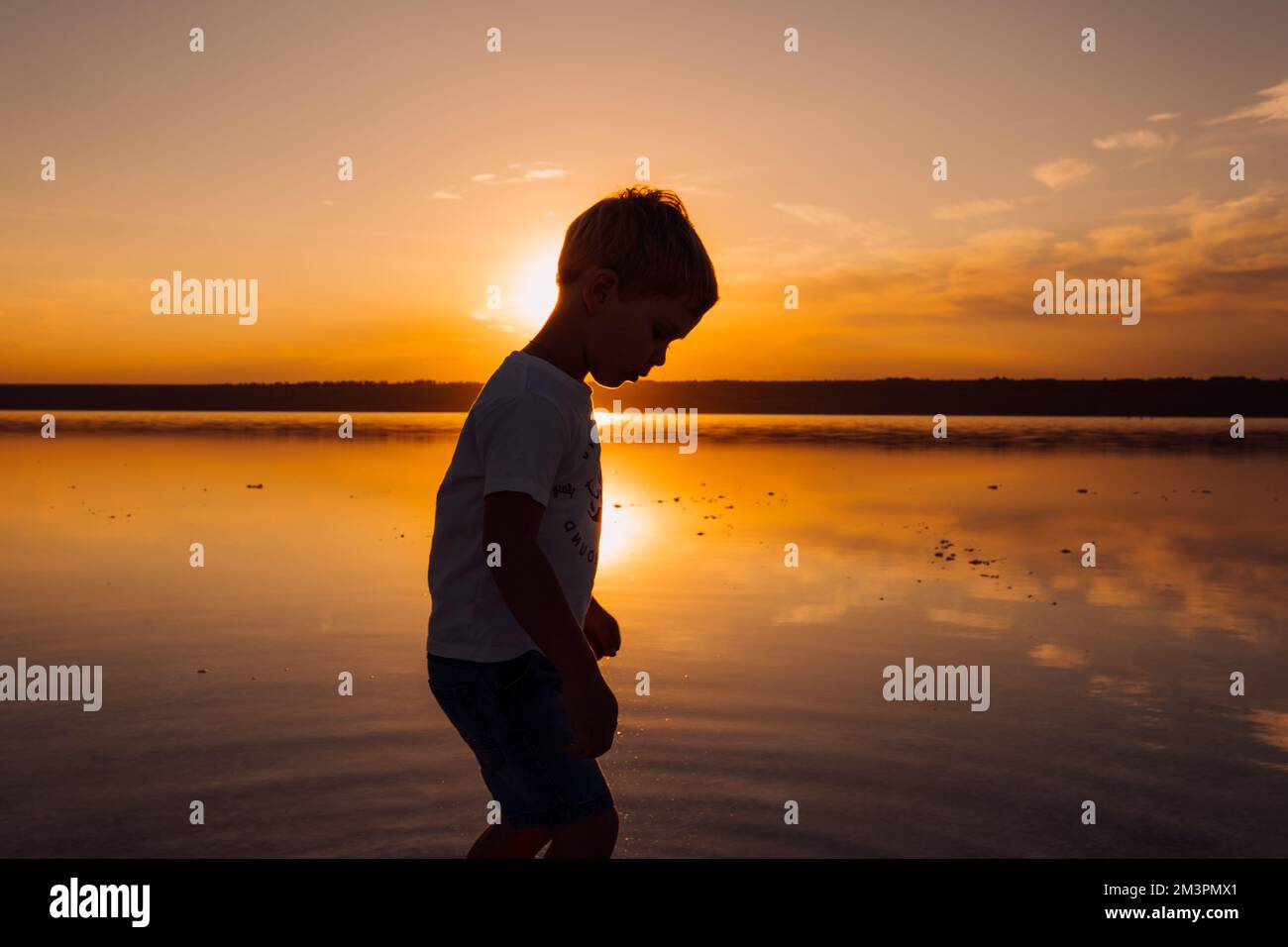 Silhouette of male child in sunlight rays. Fresh air, environment ...