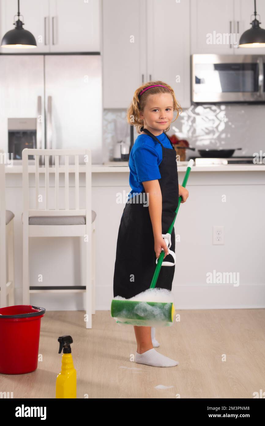 Little kid cleaning at home. Child doing housework having fun. Portrait ...