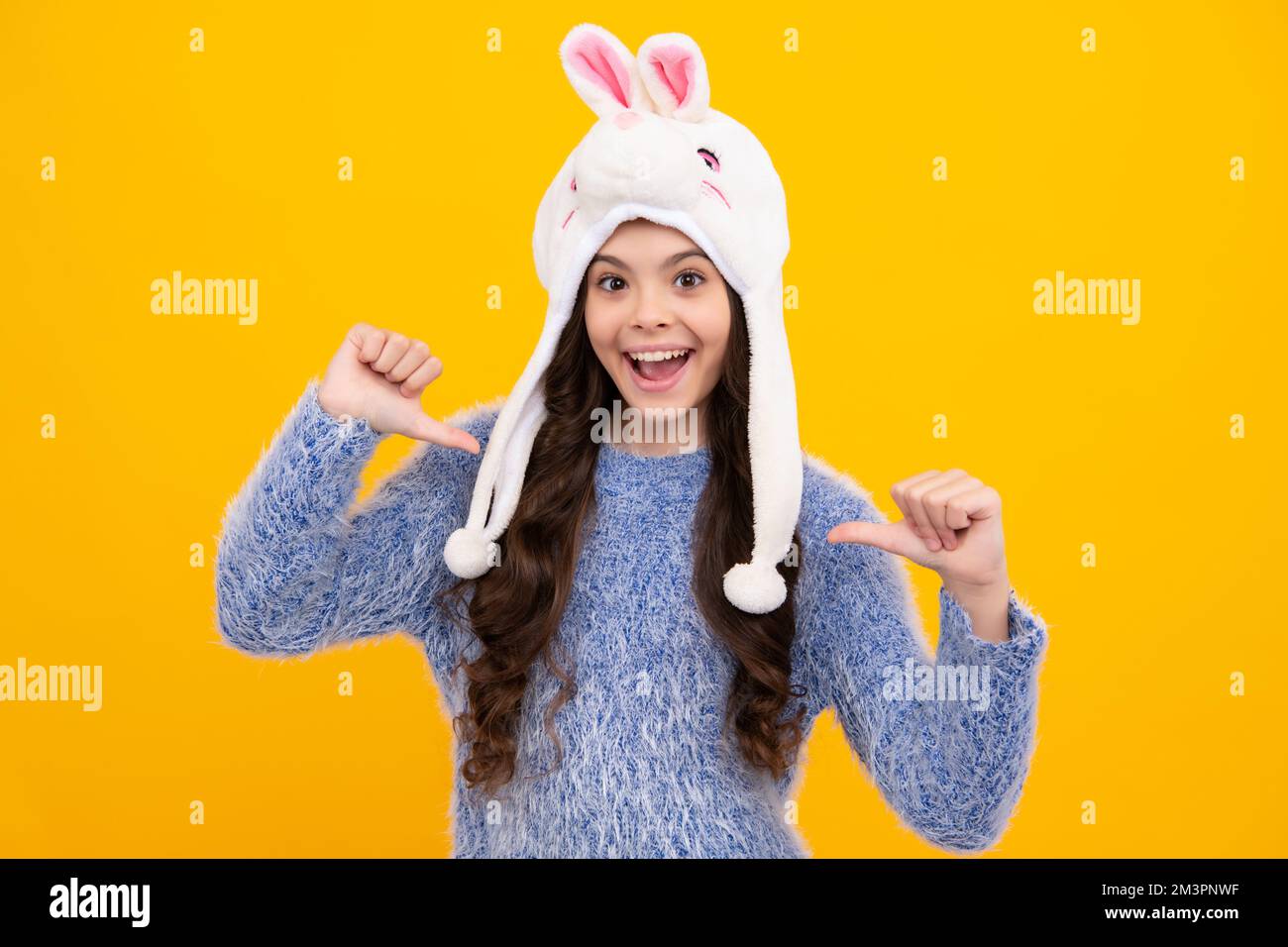 Bunny winter hat. School girl in winter clothes and warm hat. Winter ...