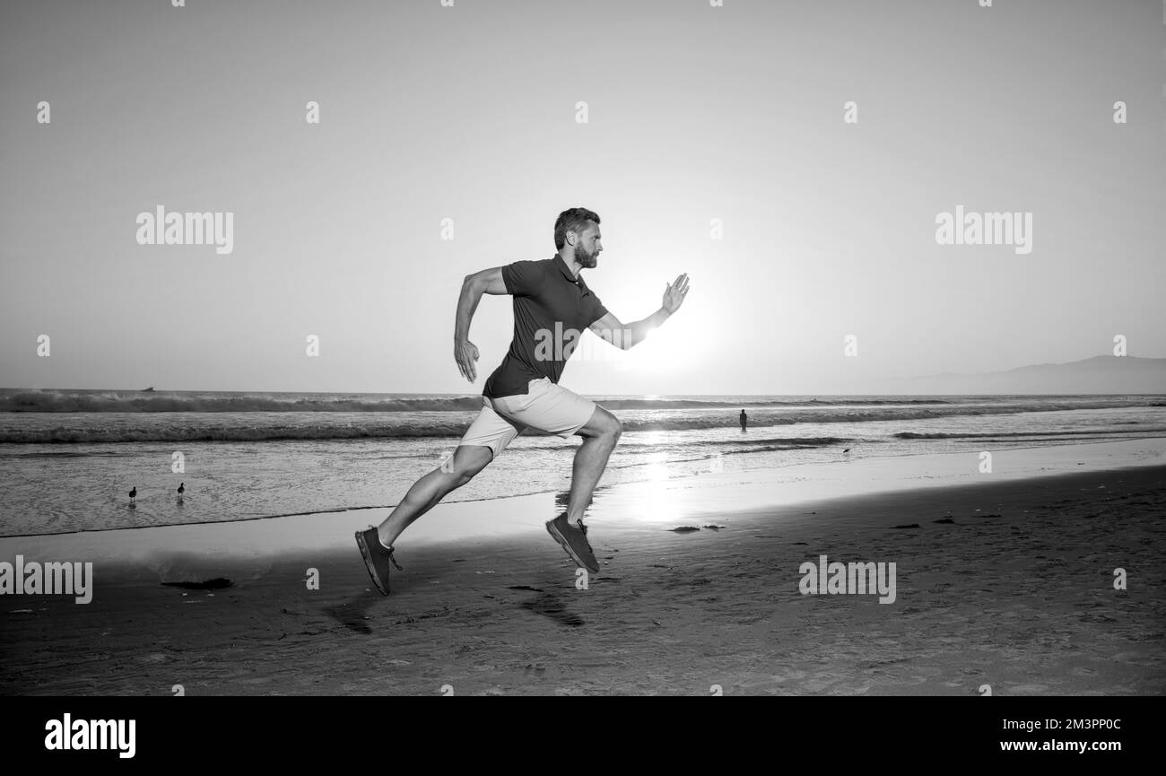 sportsman sprinter running on sunrise summer beach at ocean, jogging ...