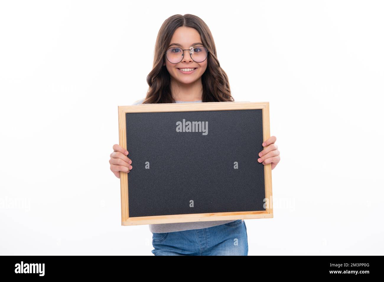 Teenager younf school girl holding school empty blackboard isolated on ...