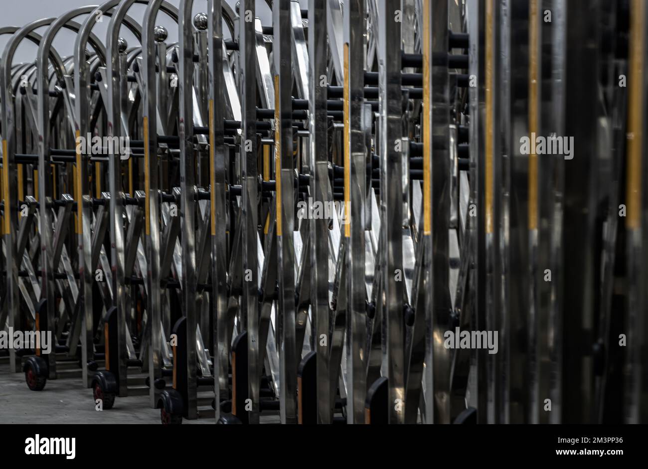 Retractable stainless steel barrier installed as a fence used to keep ...