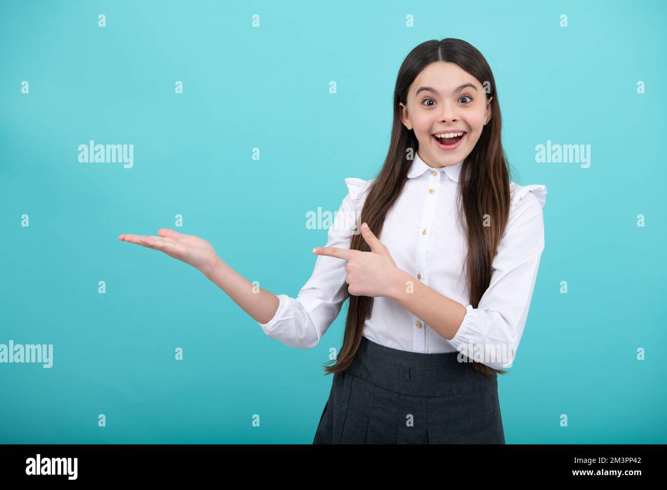Teenager child pointing to the side with a finger to present a product ...