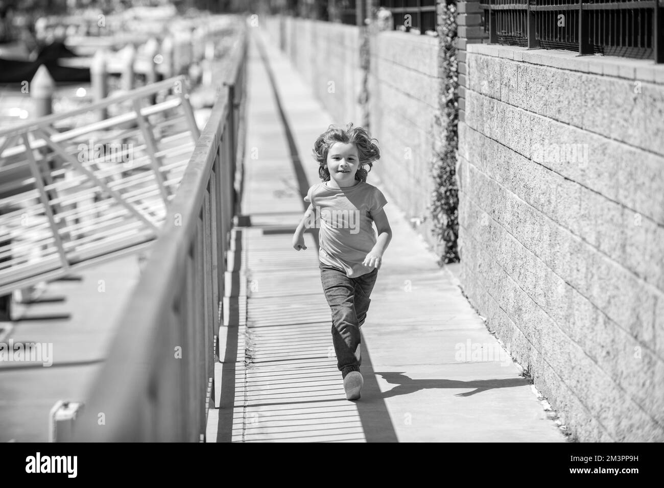 Active boy child enjoy running on promenade in summer, activity Stock ...