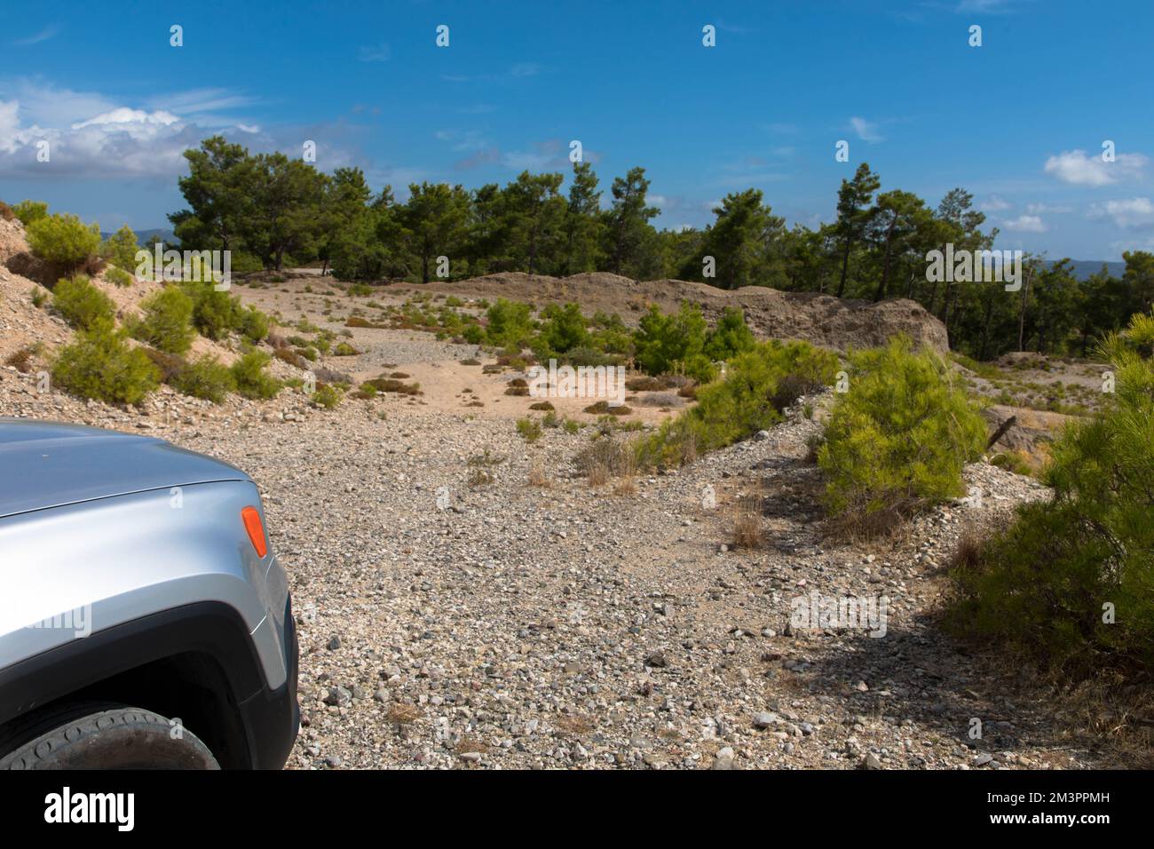 Vacation with a rental car. 4x4 off-road Jeep Renegade on dirt road on ...
