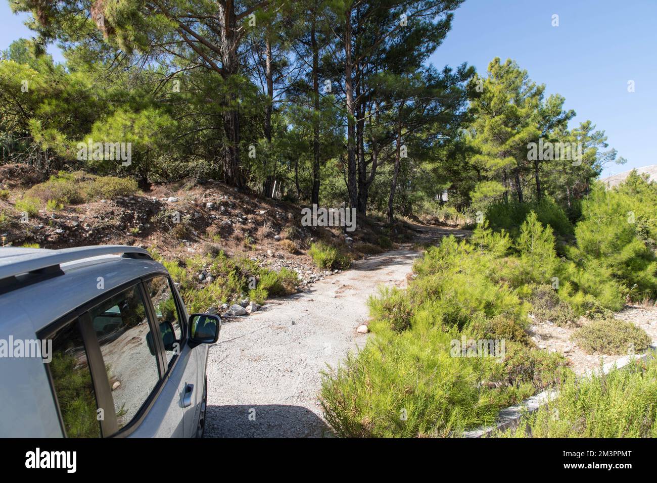 Vacation with a rental car. 4x4 off-road Jeep Renegade on dirt road on ...