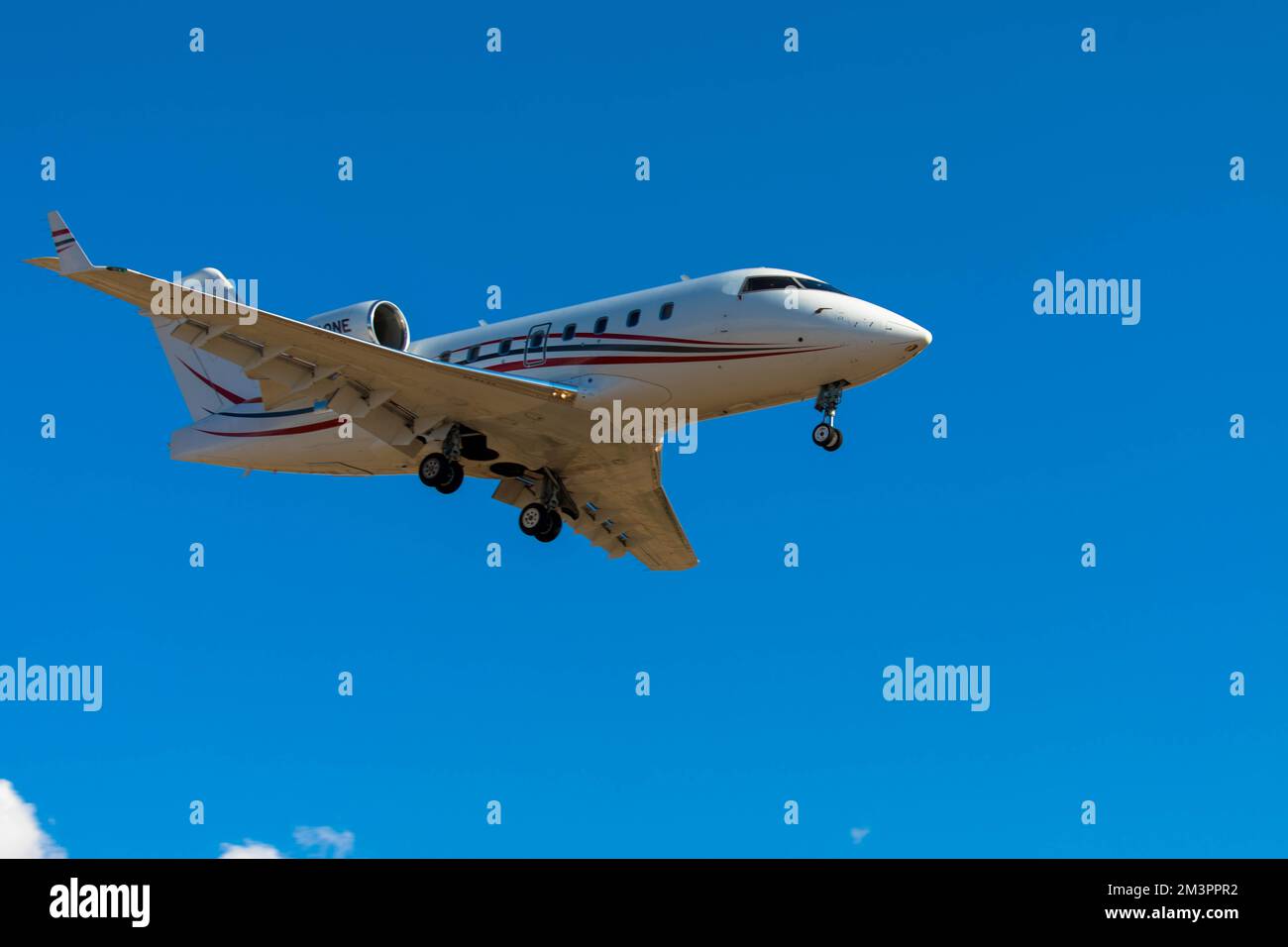 Private jet on approach for landing. Blue sky with plenty of space for ...