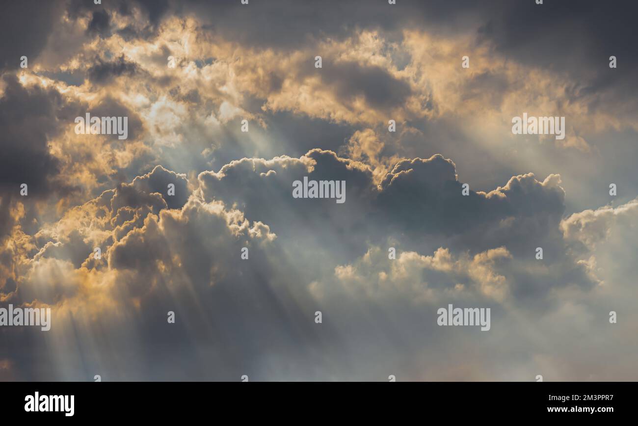 The sun's rays passing through the clouds and shining form an ...