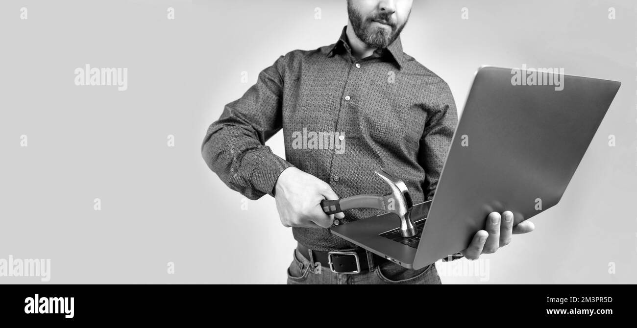 Unshaven man cropped view break laptop hitting computer with hammer ...