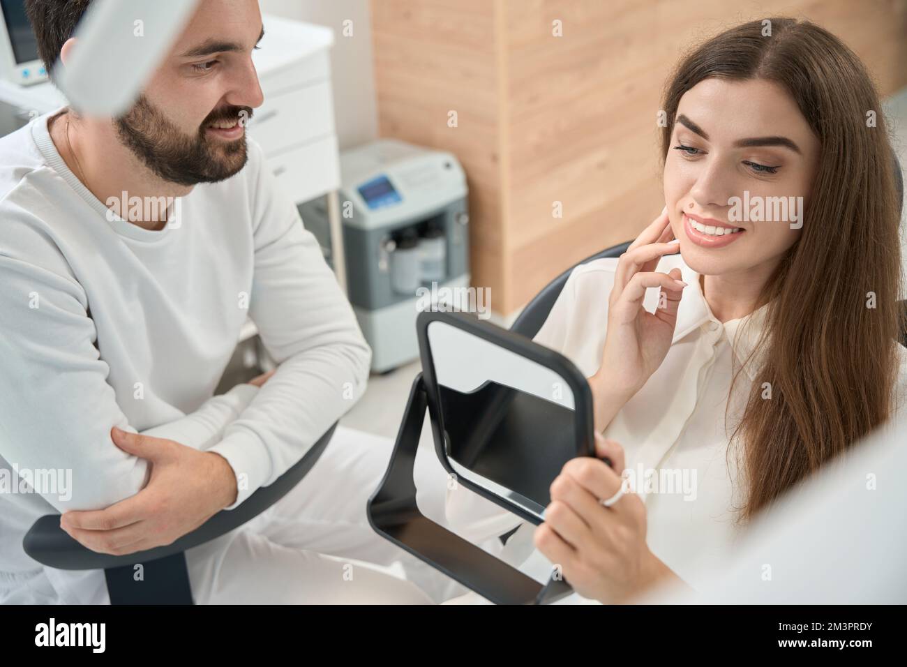 Stomatologist examining female client hi-res stock photography and ...