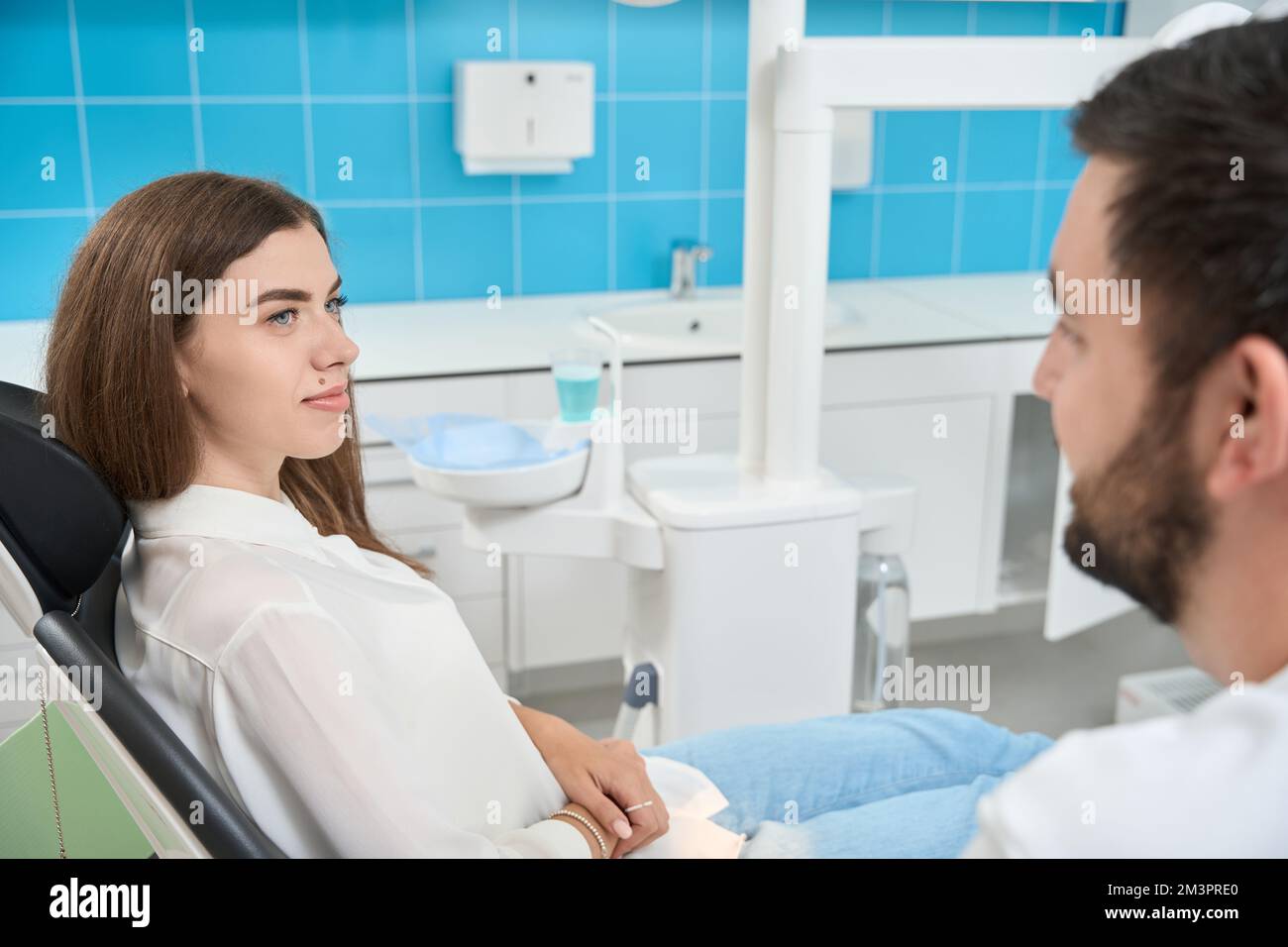 Dentist client during dental treatment hi-res stock photography and ...