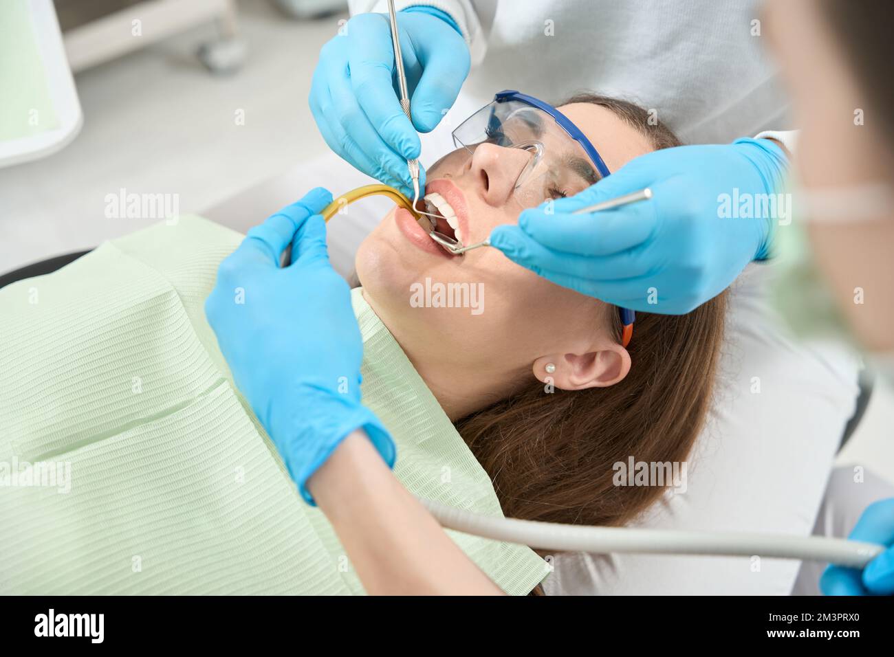Stomatologist examining client teeth with dental probe and mouth mirror ...