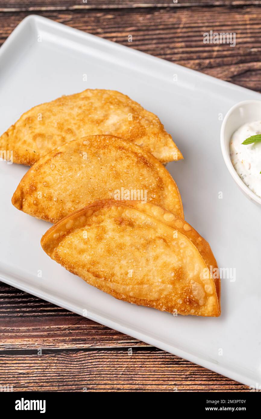 Beef Cheburek on a wooden table. Deep Fried Beef Dumplings with meat ...