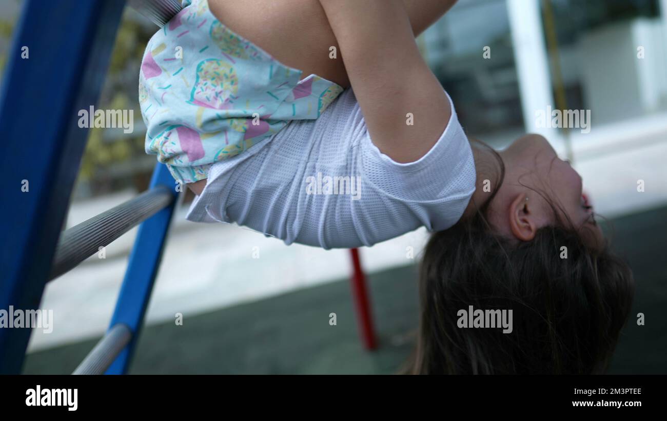 Child upside down at playground play little girl at monkey bar Stock Photo - Alamy