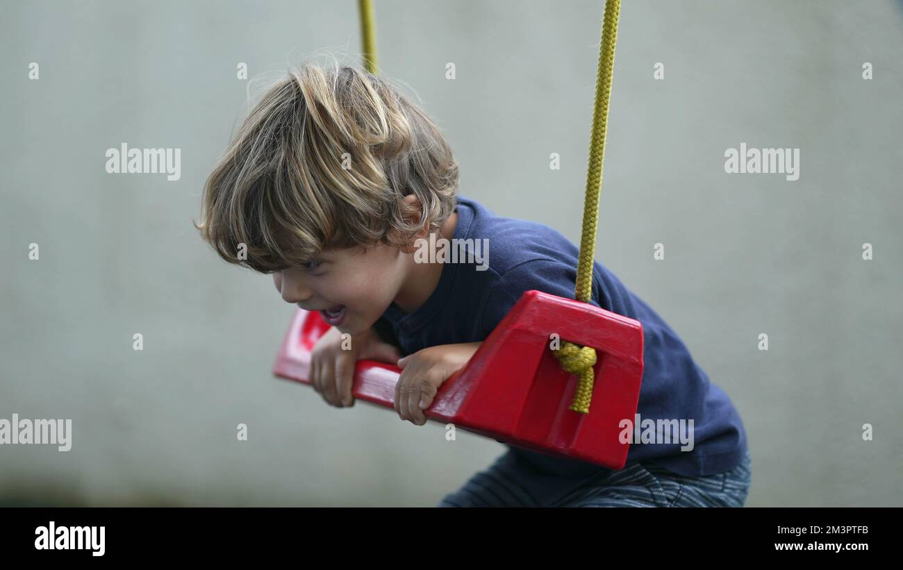 Boy twisting swing hi-res stock photography and images - Alamy