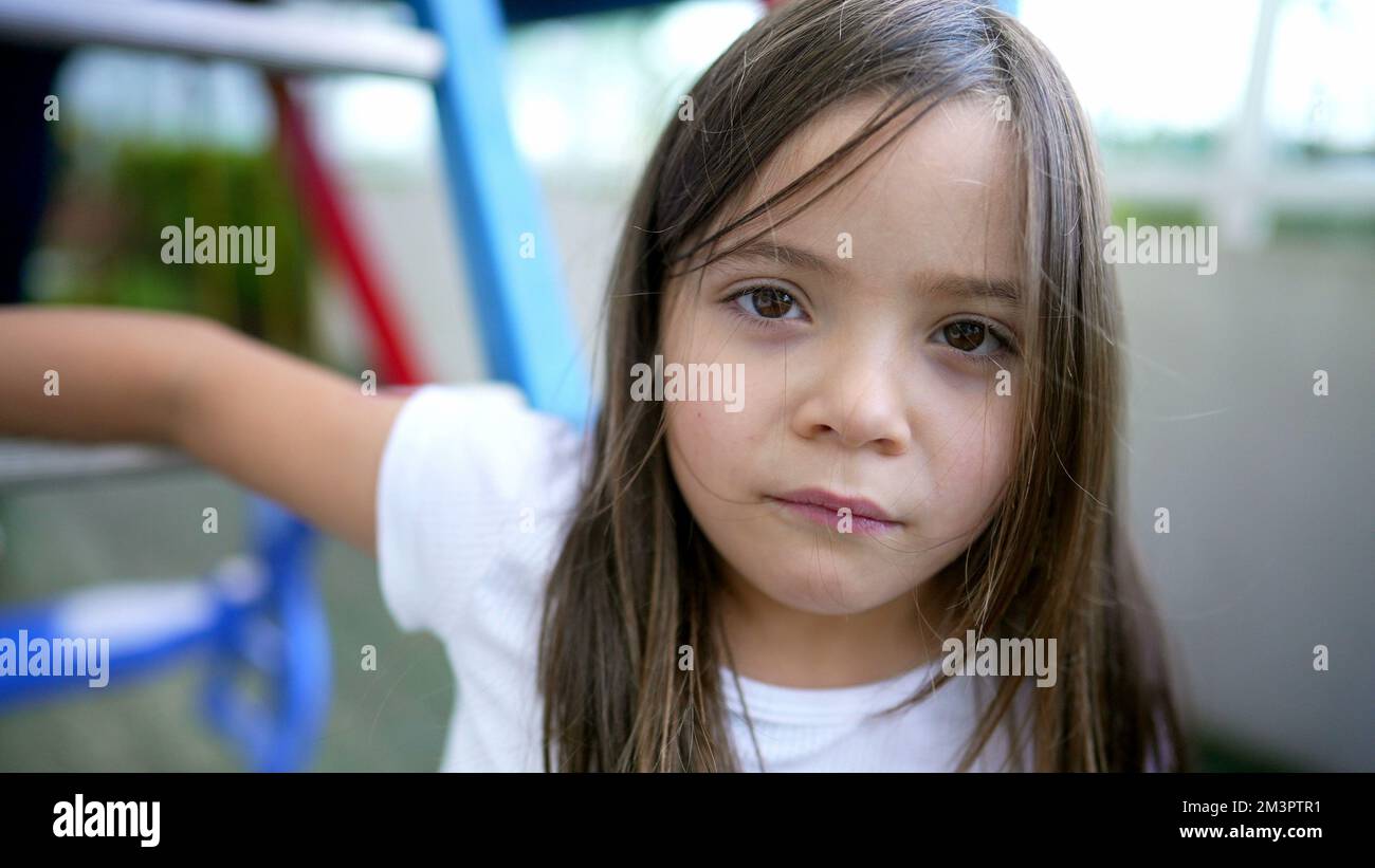 Adorable small girl portrait face grimacing at camera Stock Photo - Alamy