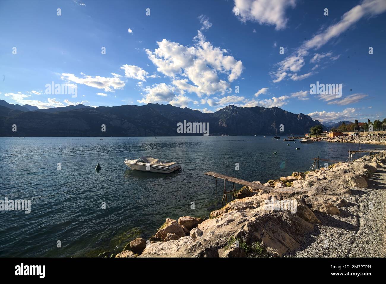 Boat next to the shore of a lake on a sunny day in summer Stock Photo ...