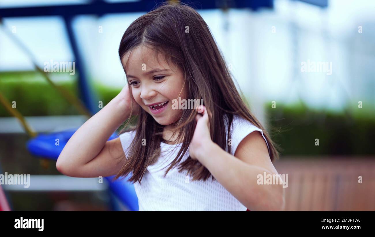 Candid adorable little girl child kid walking outside at playground ...