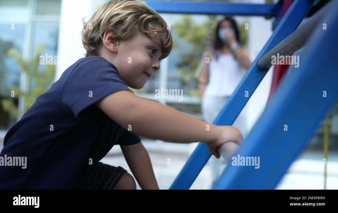 Child climbing playground ladder outside active little boy plays ...