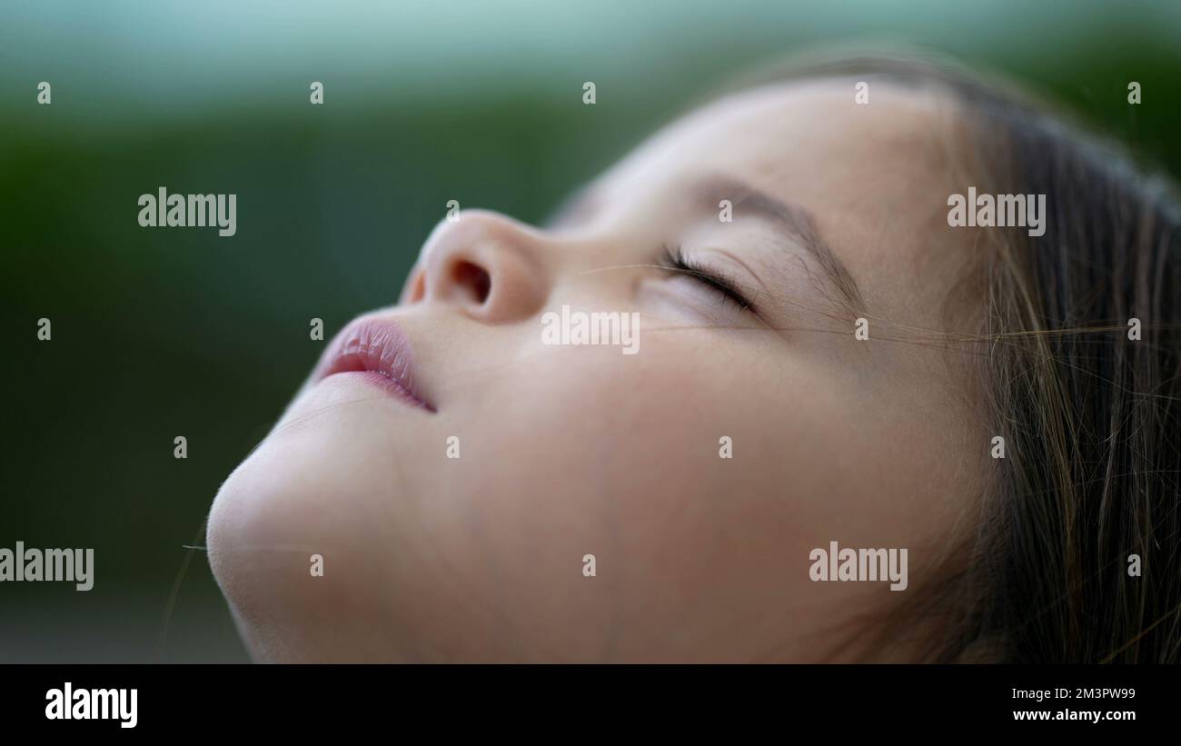 Child face looking up at sky with eyes closed pensive little girl Stock ...