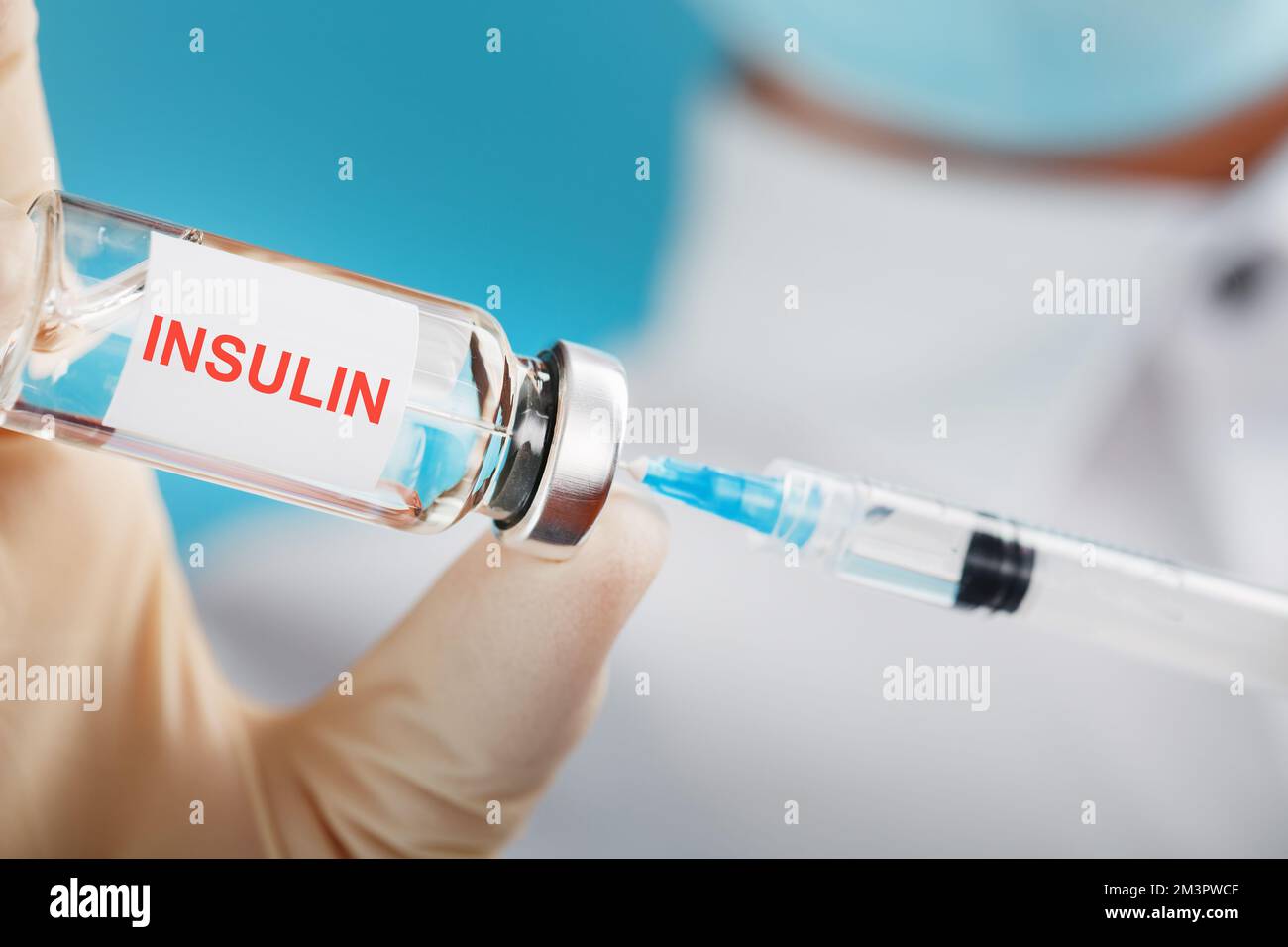 The doctor holds a syringe for injections and an ampoule with insulin ...