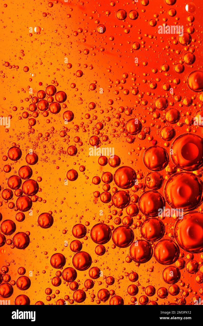 oil bubbles with water on glass and colored background Stock Photo - Alamy