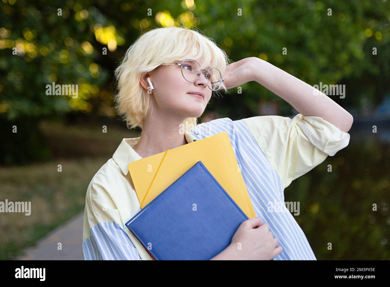 Photography with teenage girl with her books and students folders Stock ...
