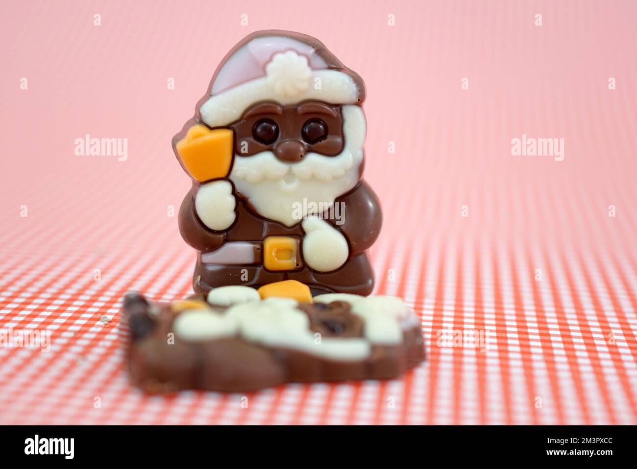 Tasty cute little chocolate Santa Claus candy on pink stripped ...