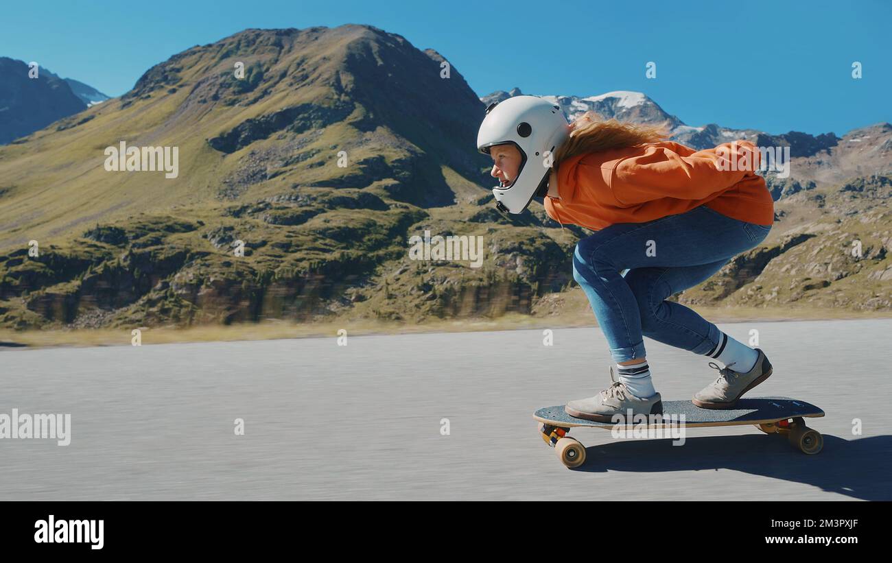 Cinematic downhill longboard session. Young woman skateboarding and ...