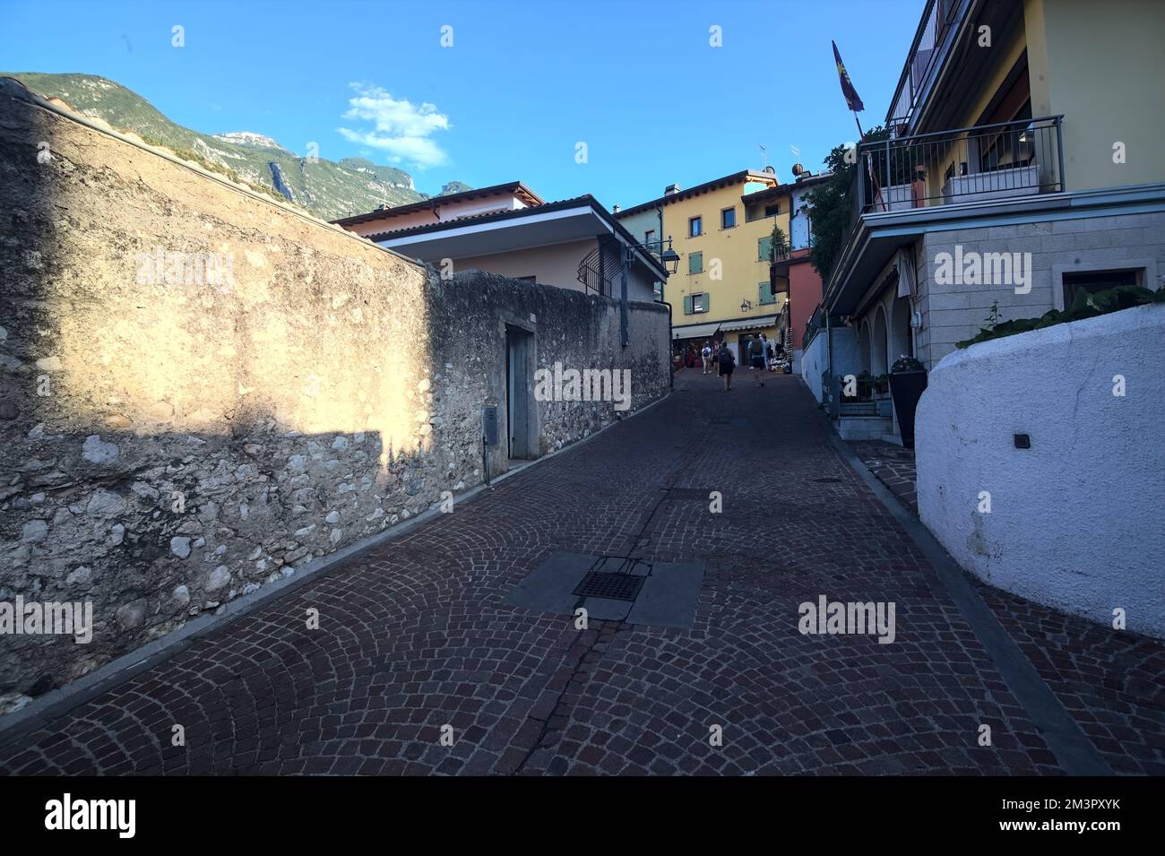 Climbing paved street on a cliff bordered by boundary walls Stock Photo ...