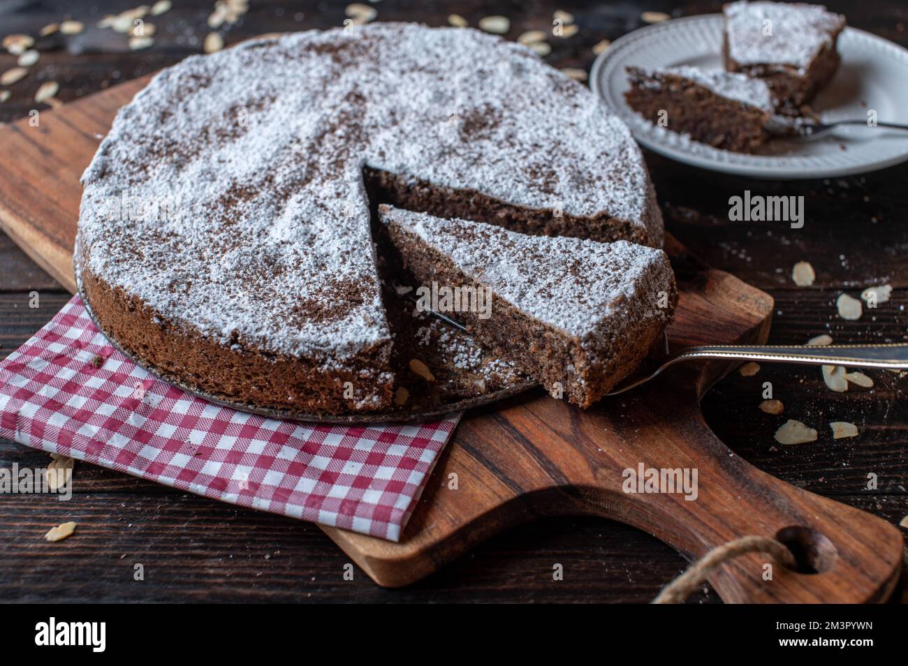 Italian almond chocolate cake, torta caprese on wooden table. Gluten ...