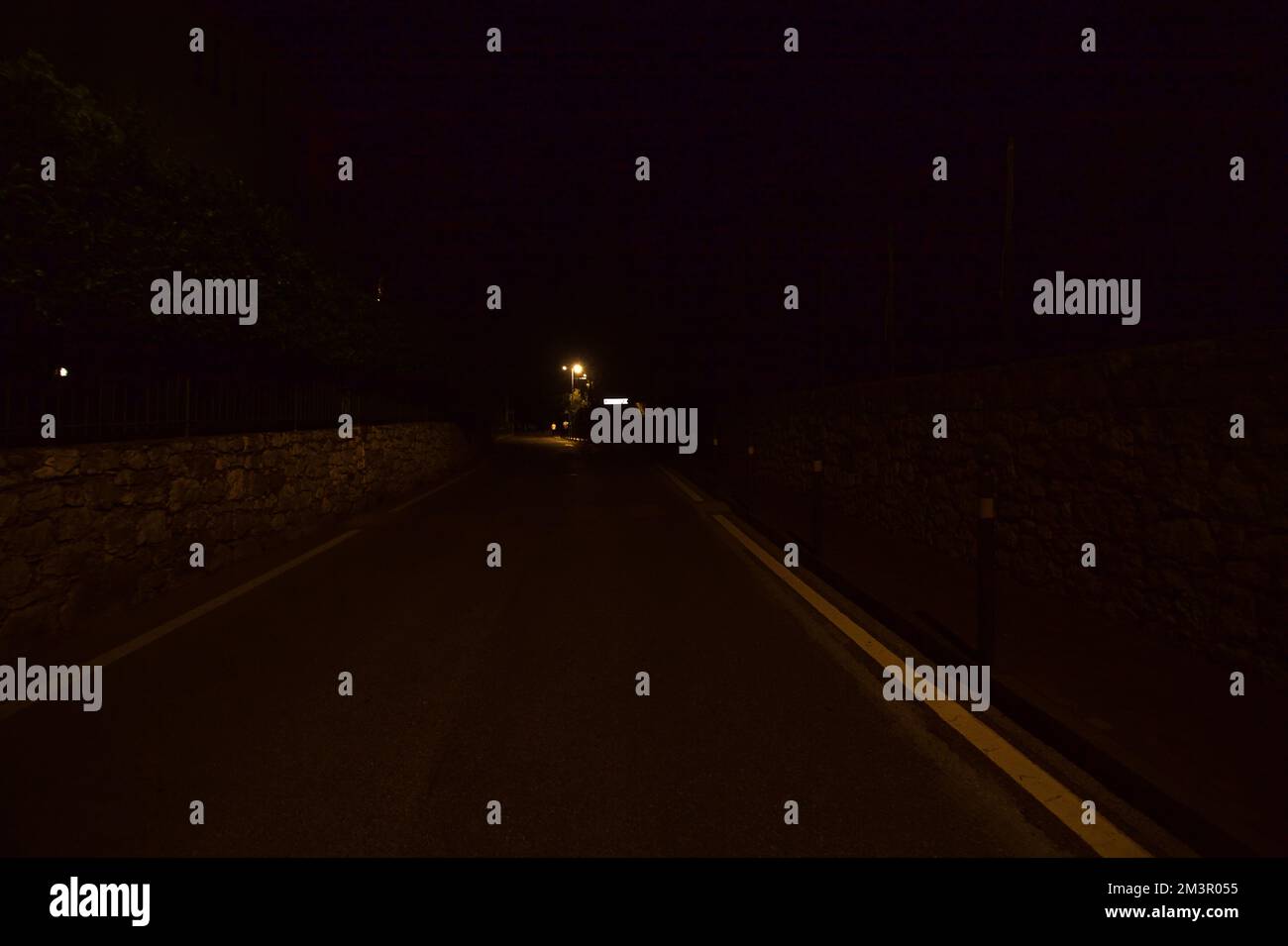 Country road with street lamps at night Stock Photo - Alamy