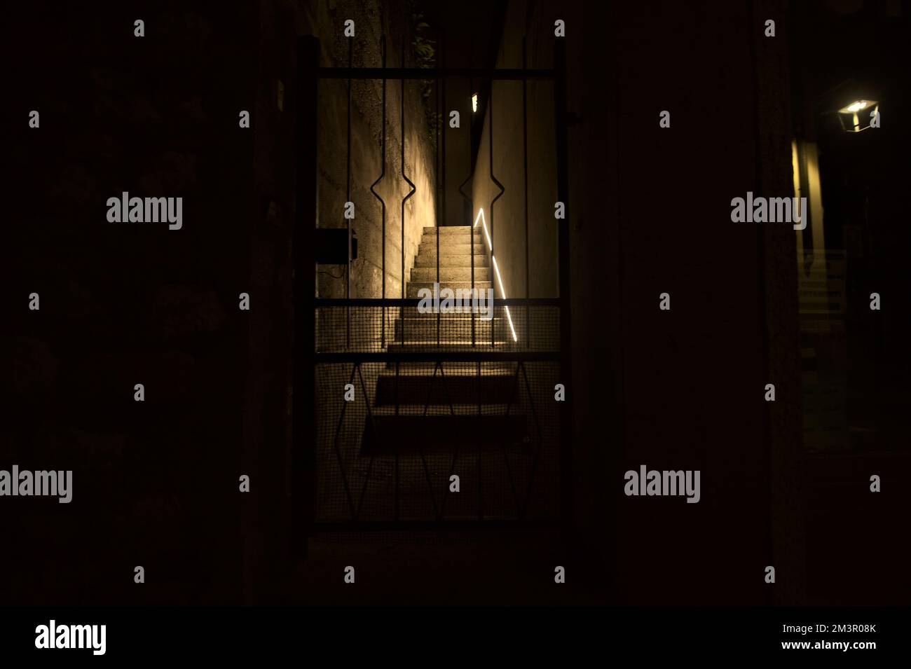 Staircase blocked by a metallic gate at night Stock Photo - Alamy